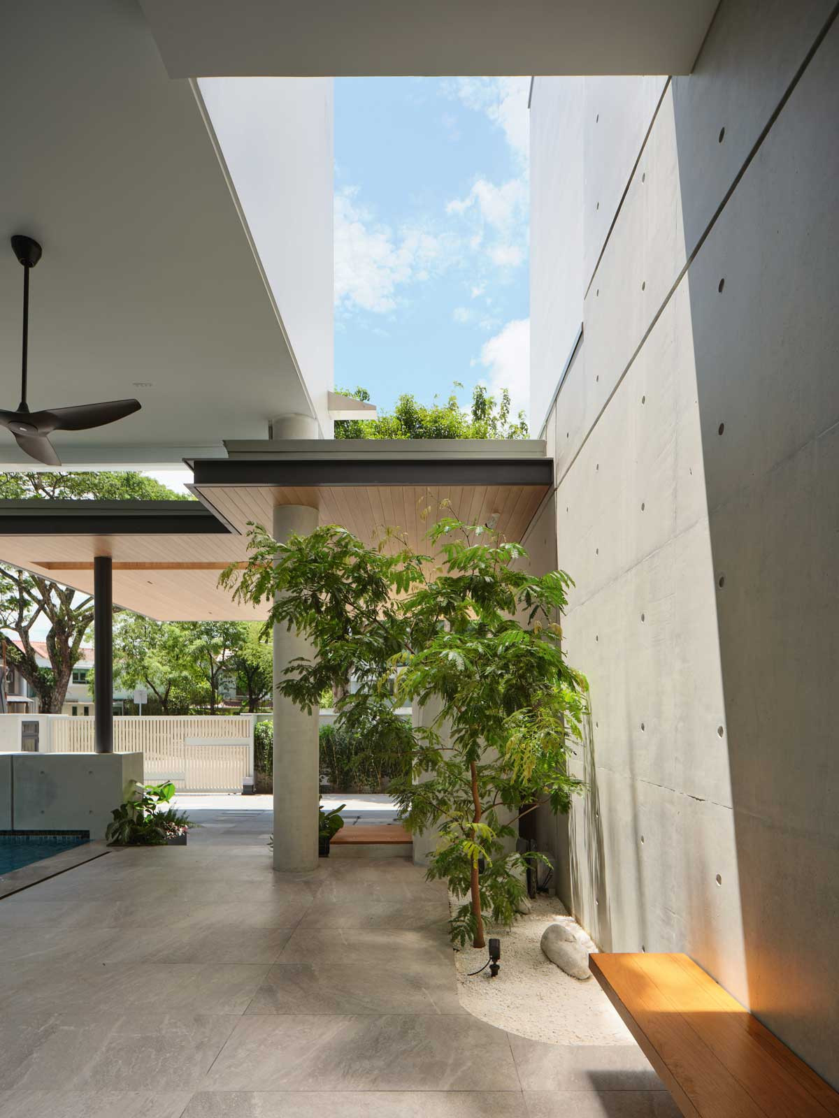 Inside this semi-detached house with a void deck by RT+Q Architects ...